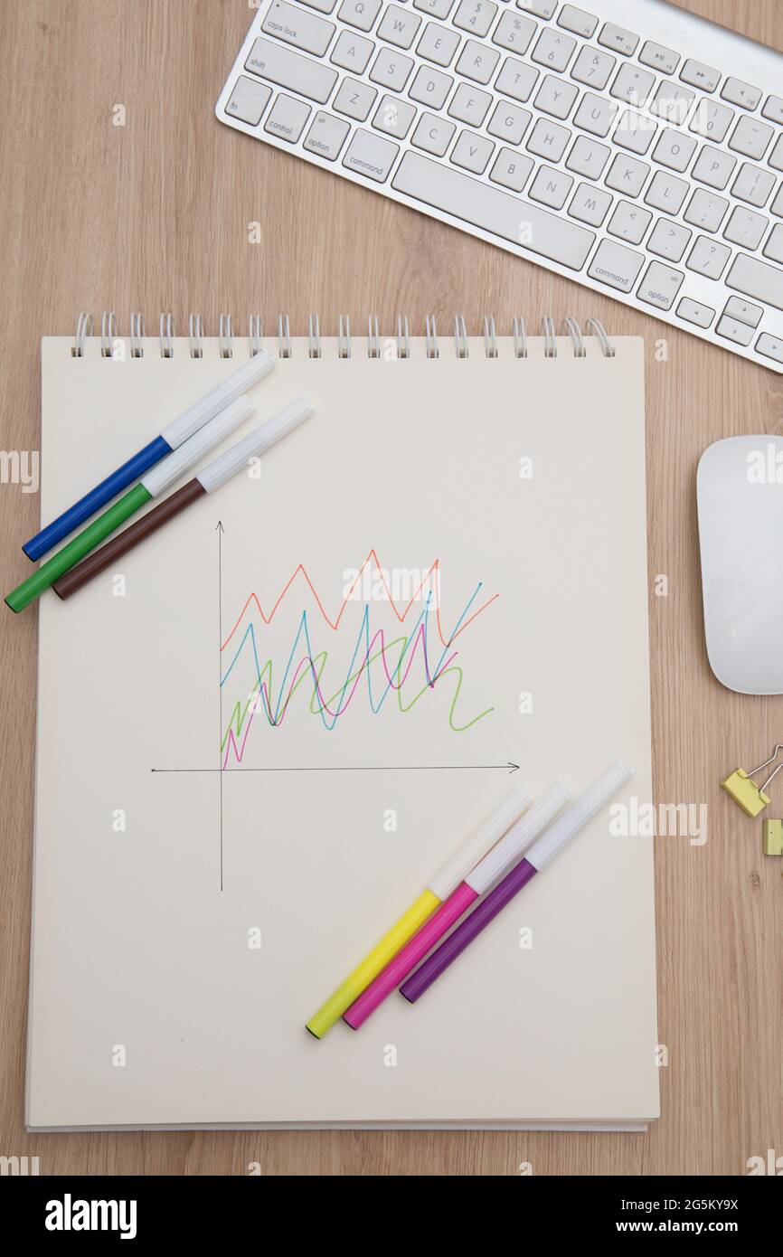 Shot of a white keyboard and painted graphs Stock Photo - Alamy