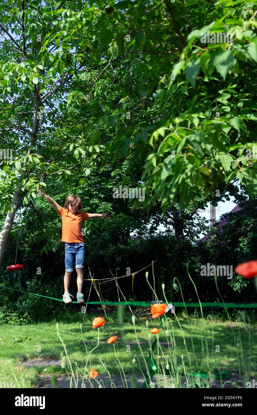 Little boy balances on a slackline Stock Photo - Alamy