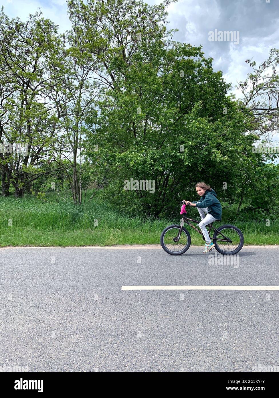 boy rides a bicycle in the countryside Stock Photo - Alamy