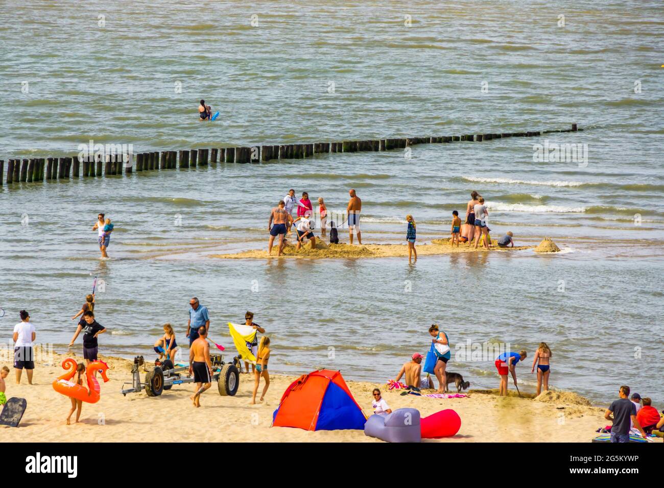 Tourists recreating on the beach of Breskens during summer season ...