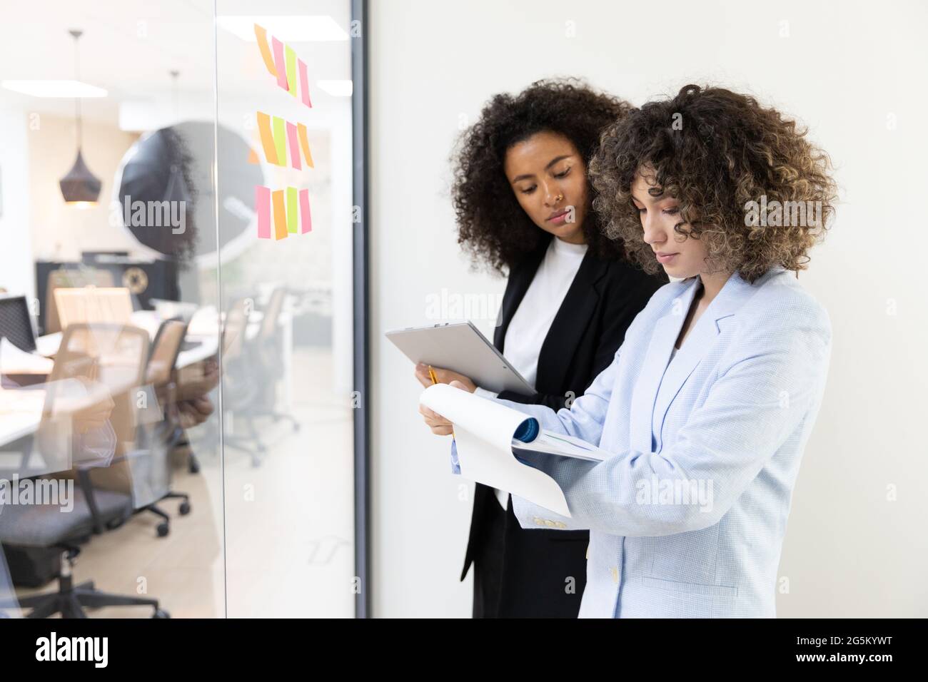 Multicultural coworkers using white board and doing brainstorming ... Multicultural coworkers using white board and doing brainstorming ...