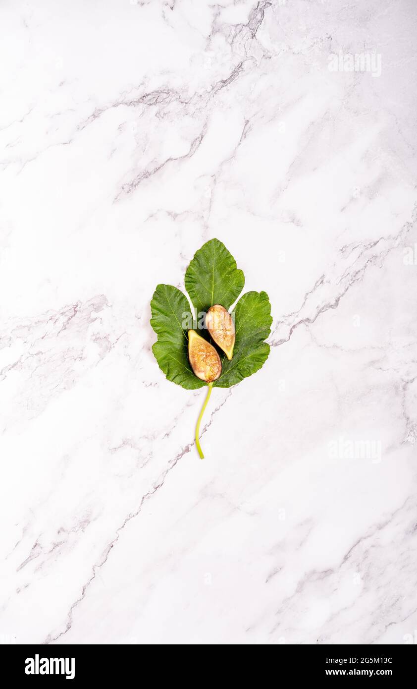Bright photography of figs and a fig leaf on a marble table Stock Photo ...