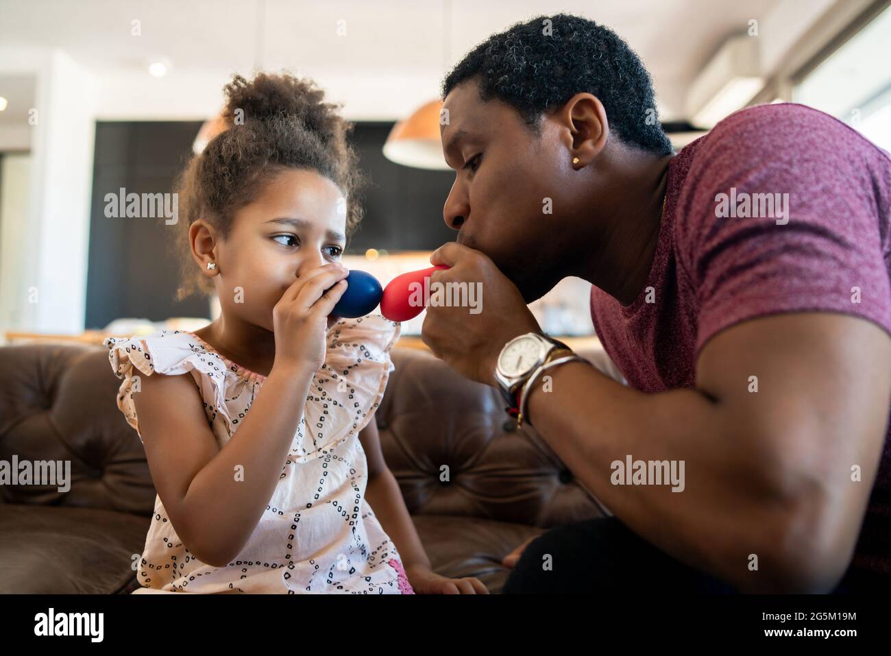 Daughter and father playing together at home Stock Photo - Alamy