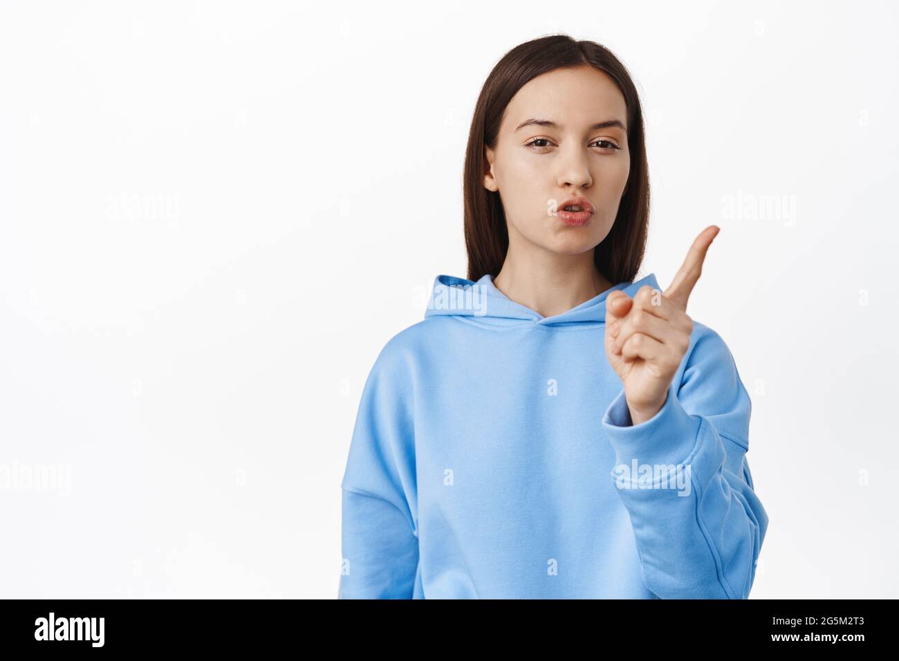 Not so fast. Young serious girl scolding you, shaking finger in ...