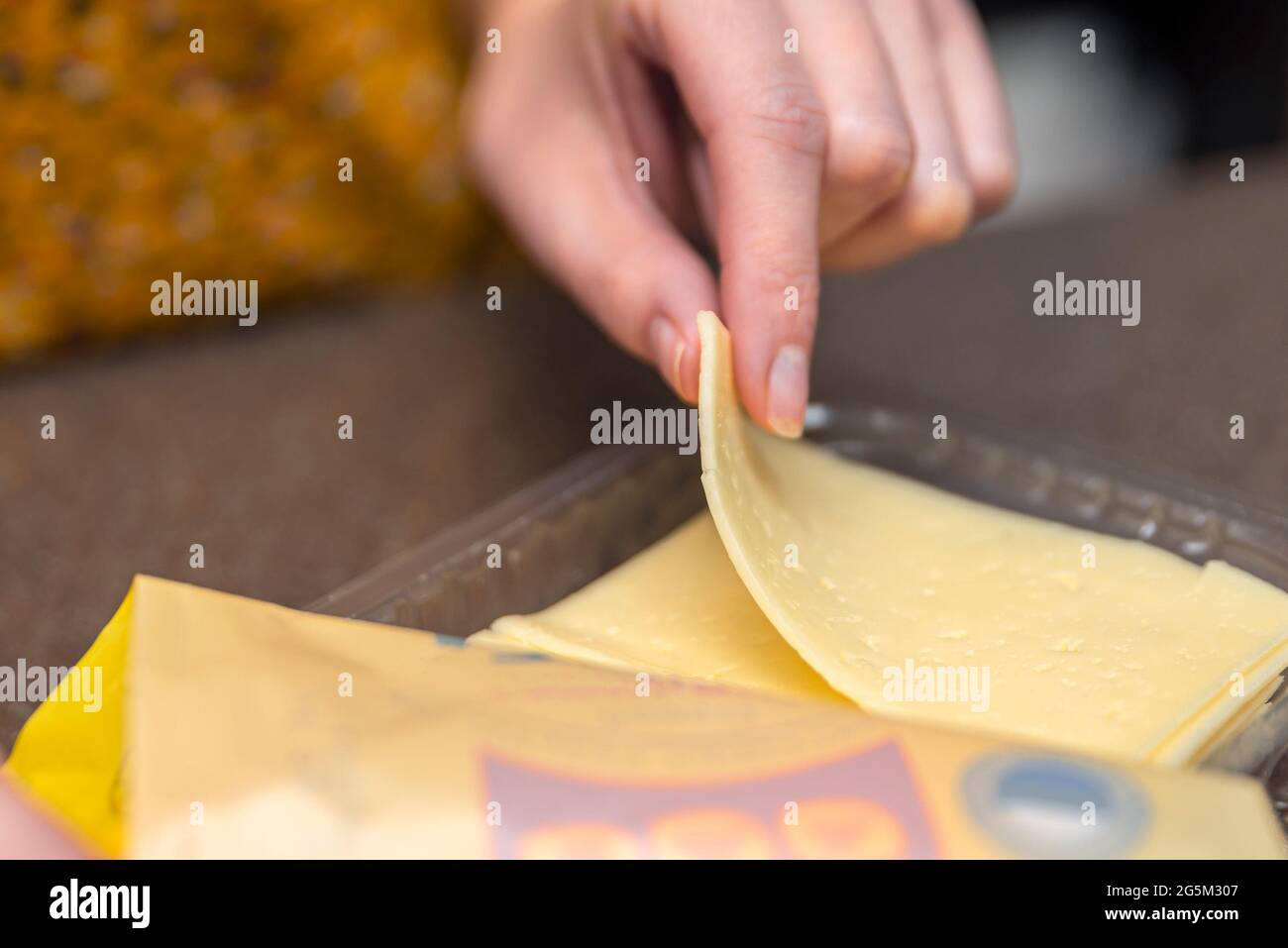 Opens a bag of sliced cheese, a woman opens a bag of cheese, cheese ...