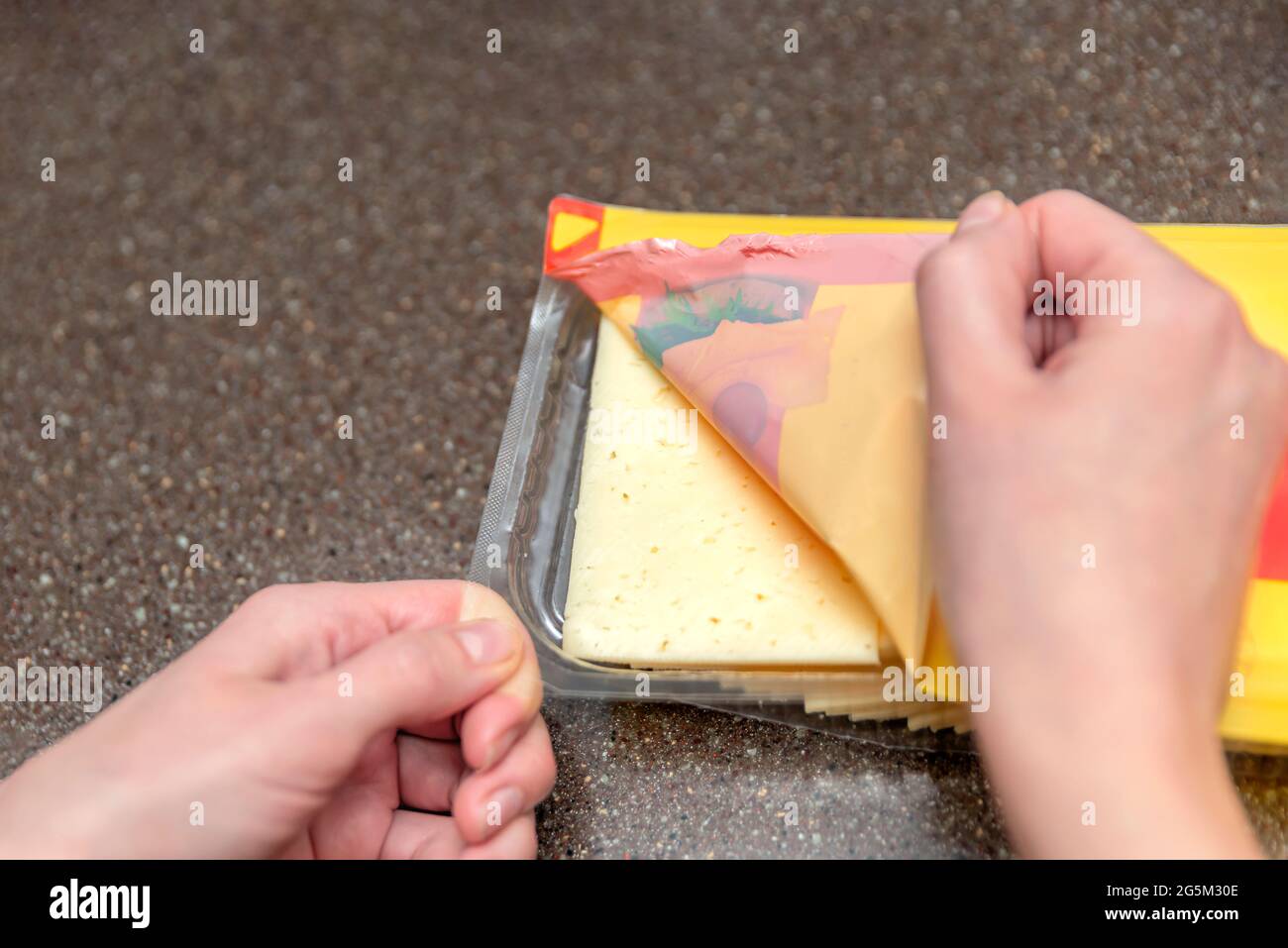 Opens a bag of sliced cheese, a woman opens a bag of cheese, pieces of ...