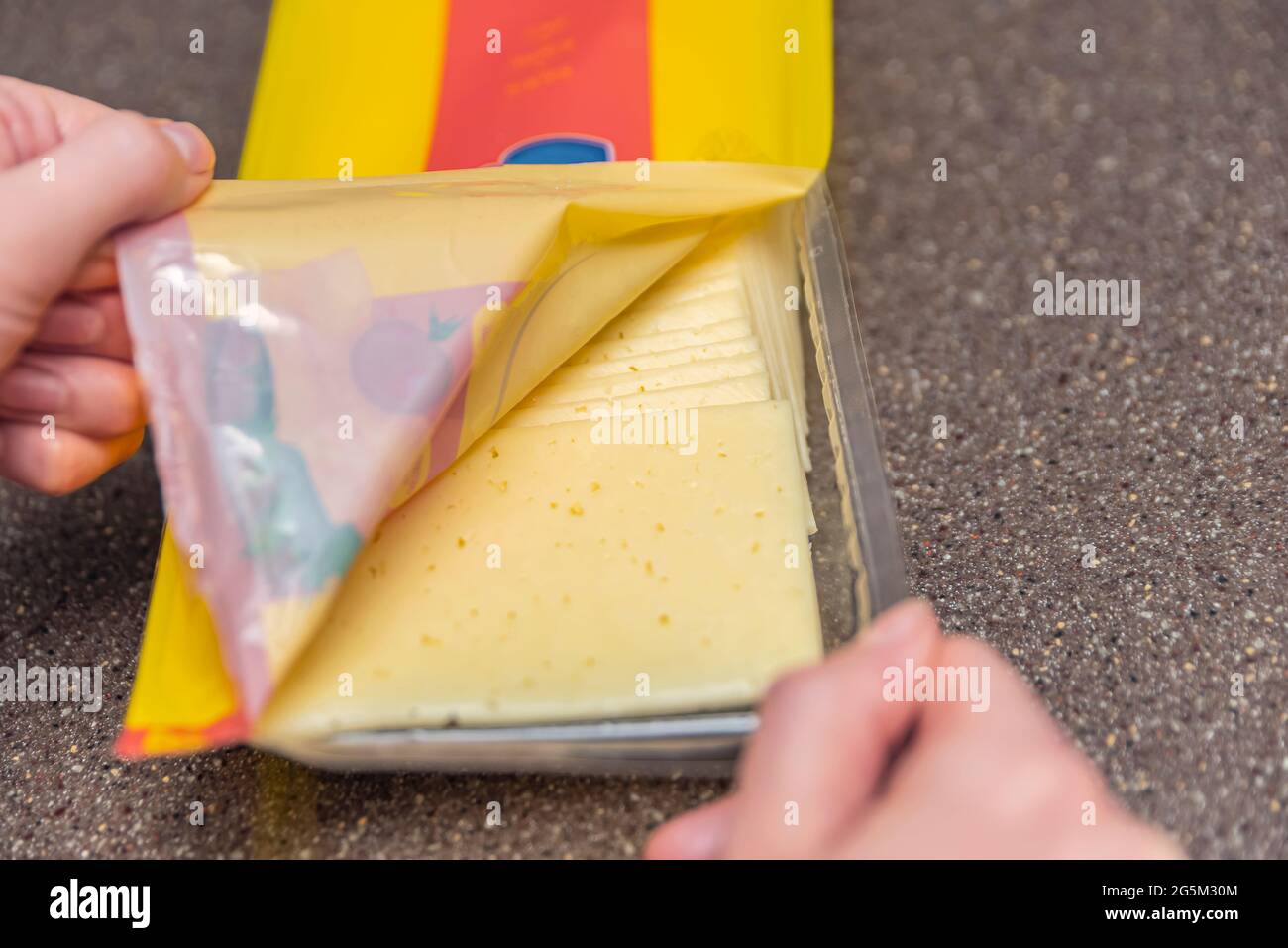 Opens a bag of sliced cheese, a woman opens a bag of cheese, pieces of ...