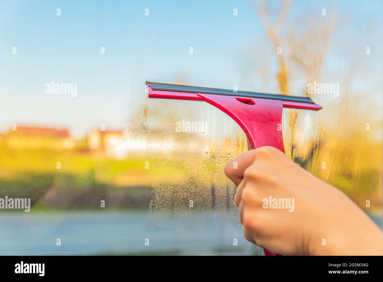 Condensation drops on the window. woman removes condensation from ...