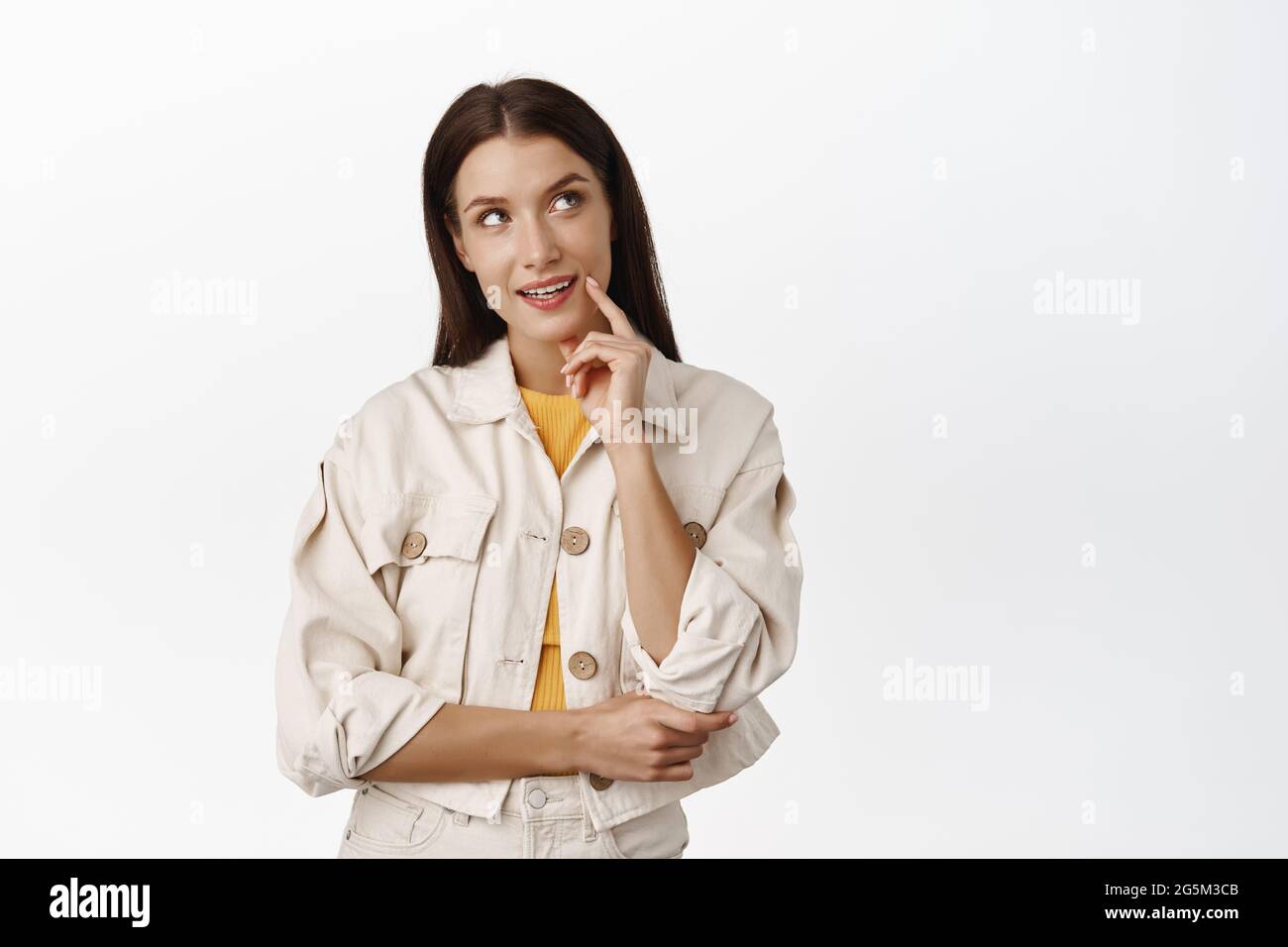 Intrigued adult woman making choice, imaging smth interesting, looking ...