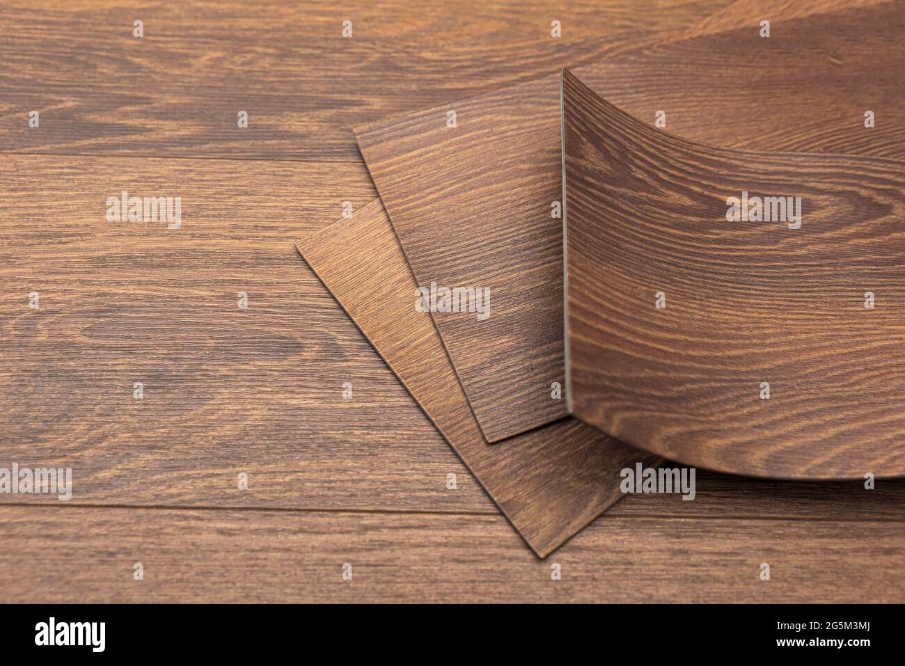 PVC vinyl sample. Vinyl floors. The swatches are brown with a woody ...