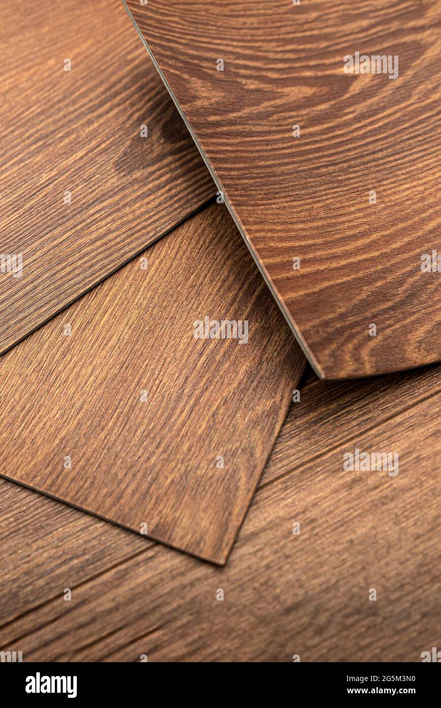 PVC vinyl sample. Vinyl floors. The swatches are brown with a woody ...