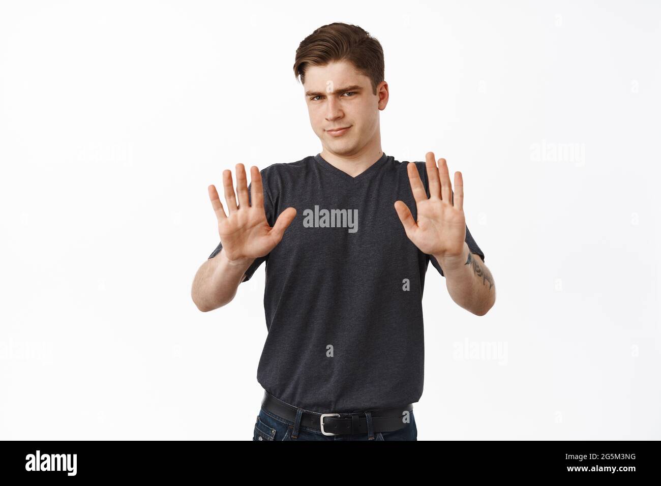 No thanks, stop. Reluctant young man shaking hands and step back from ...