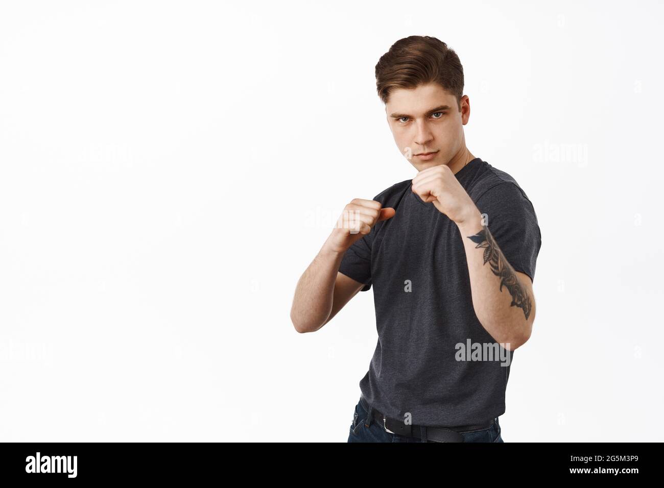 Image of confident young man ready for fight, standing in boxing ...