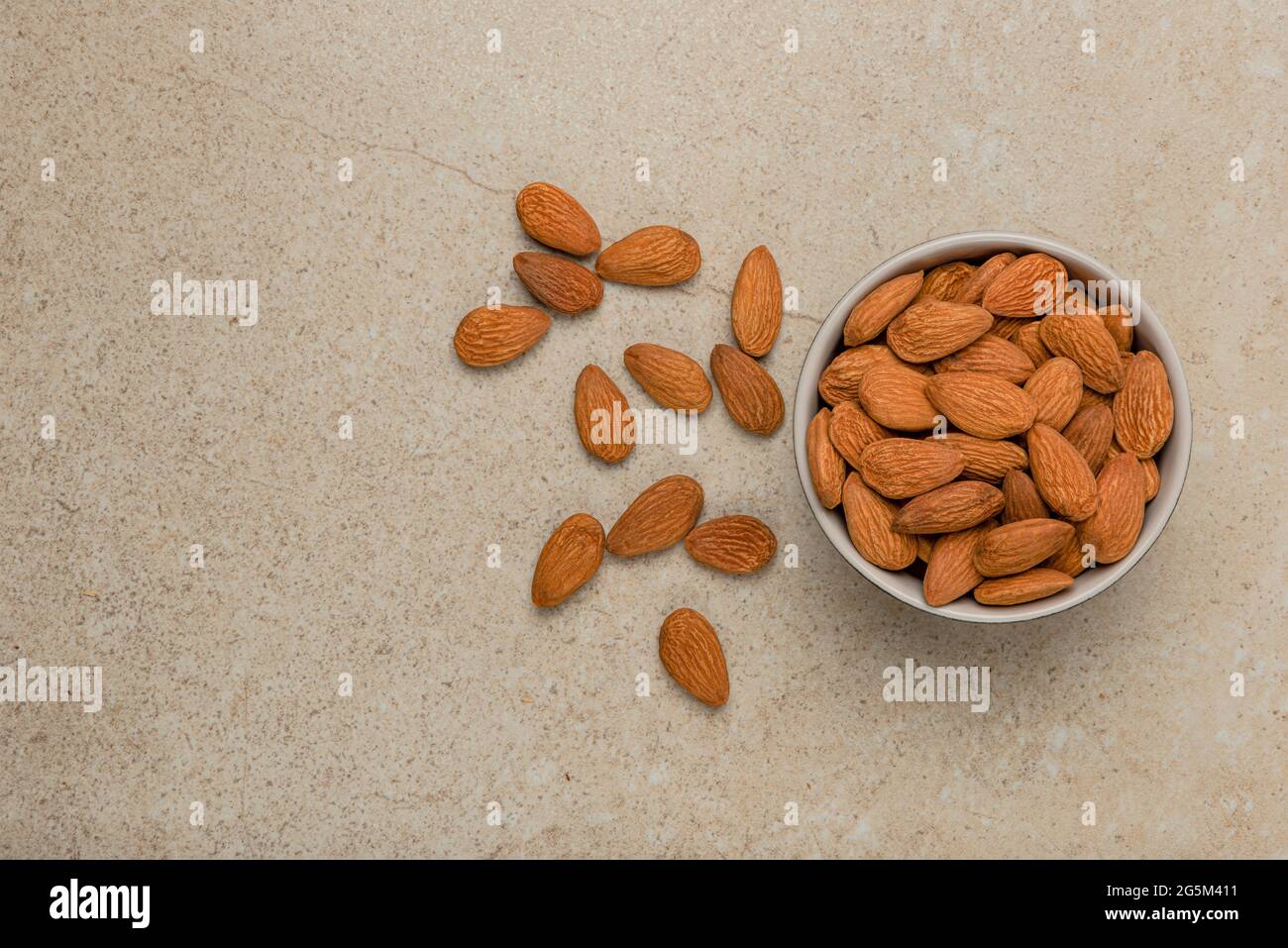 Peeled almonds. Nut background, banner, almonds in top view in a saucer ...
