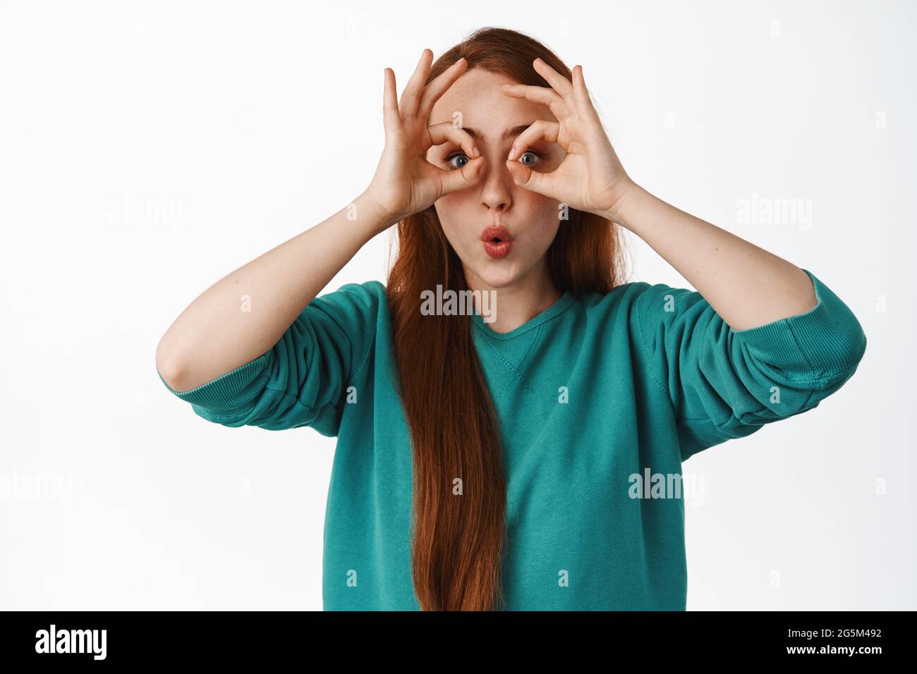 Wow super interesting promo. Excited redhead woman looking through ...