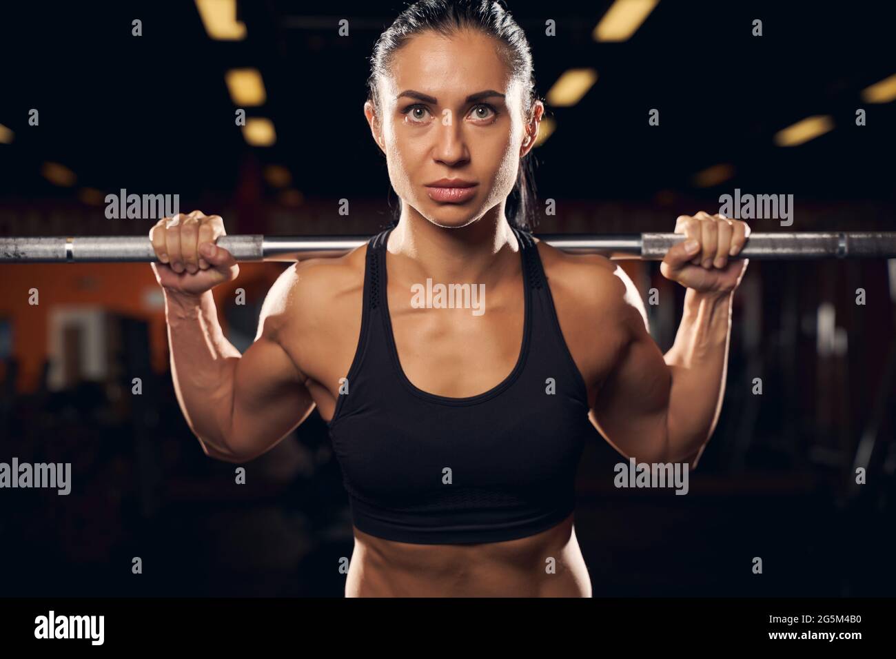 Determined beautiful sportswoman weightlifting at the gym Stock Photo ...