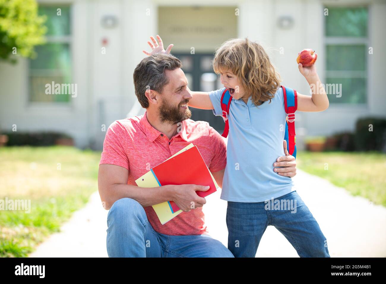 Father walking son to school. Father leads a little child school boy in ...