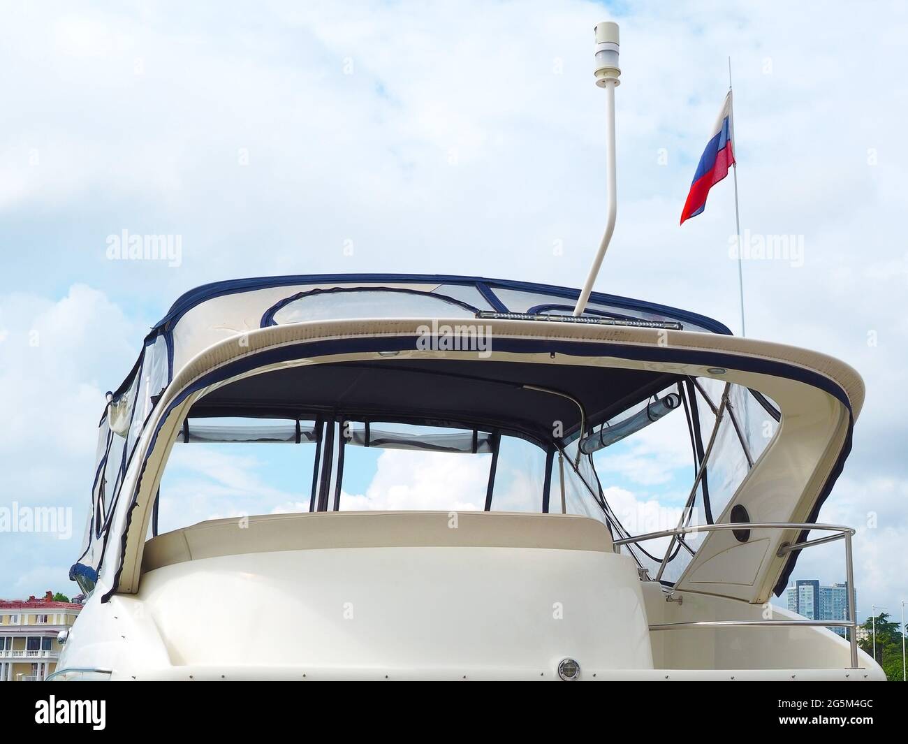 The upper part of yacht with the tricolor Russian flag against the blue ...