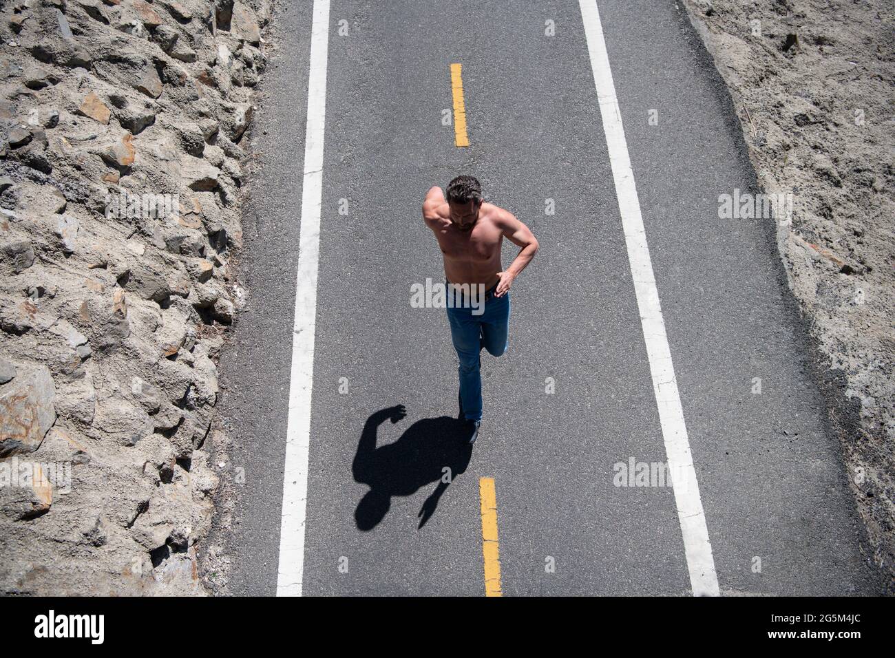 Sporty man runner running in summer. Top view of sportsman running on ...