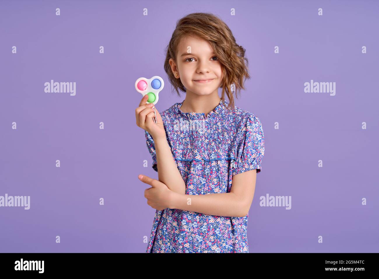 Picture of little girl with a modern popit toy. Colorful and bright pop ...