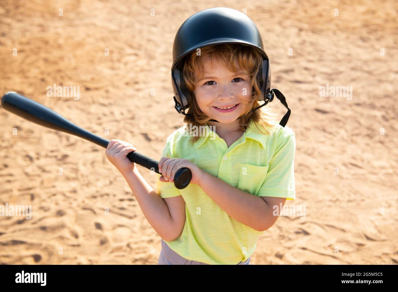 Child baseball player focused ready to bat. Kid holding a baseball bat ...