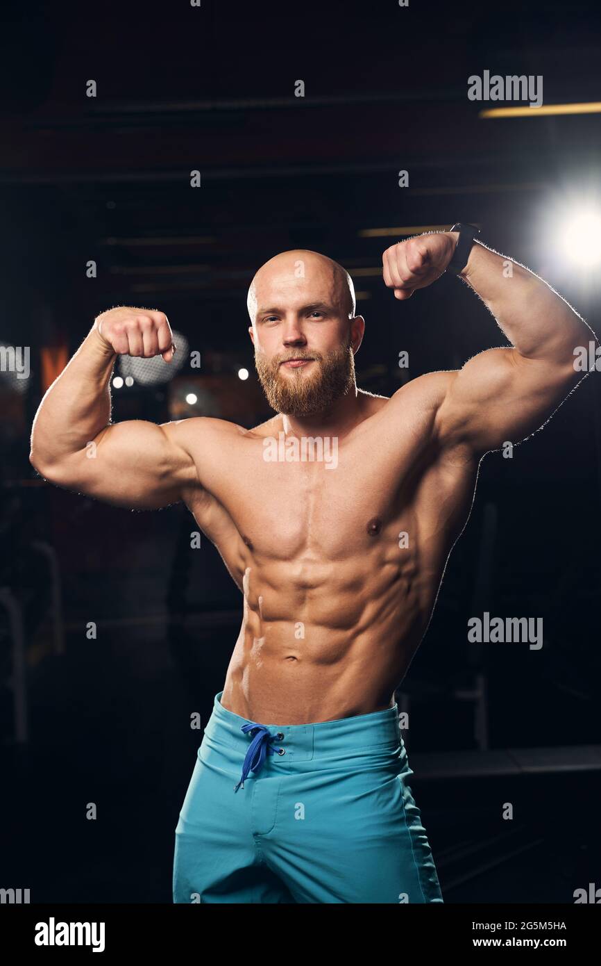 Handsome young athlete wearing shorts and flexing his muscles Stock ...