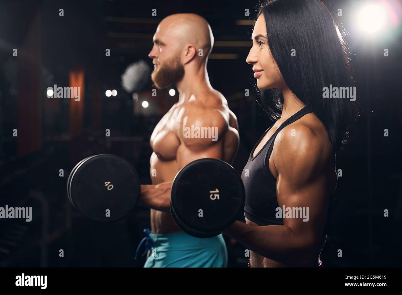 Couple of bodybuilders working hard at the gym Stock Photo - Alamy