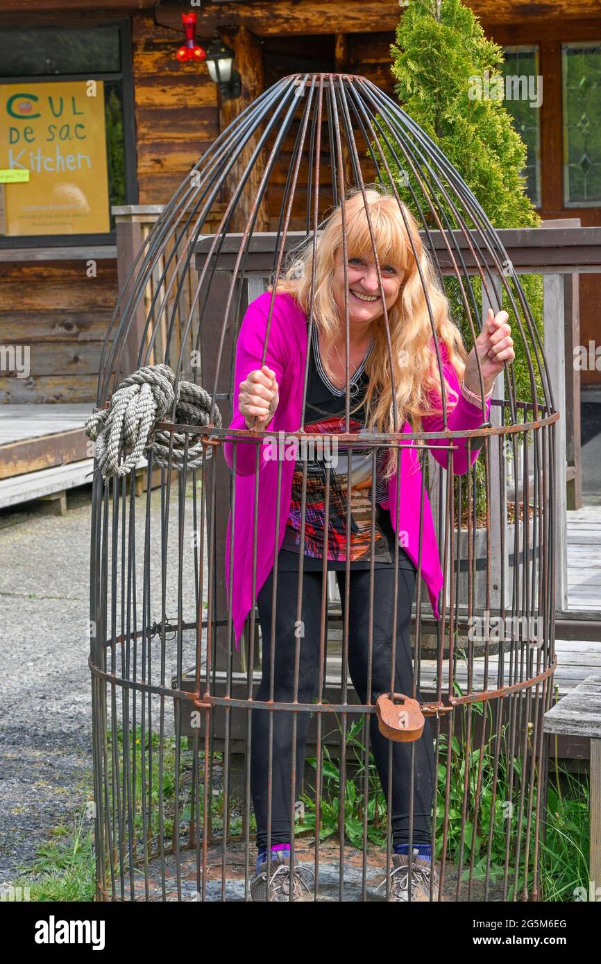 Woman in bird cage Stock Photo - Alamy