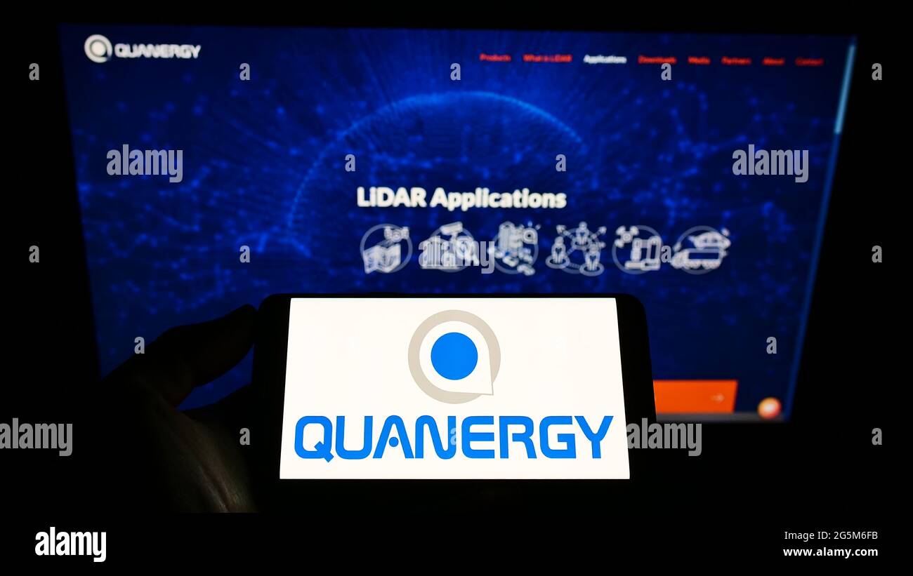 Person holding cellphone with logo of US LiDAR company Quanergy Systems ...