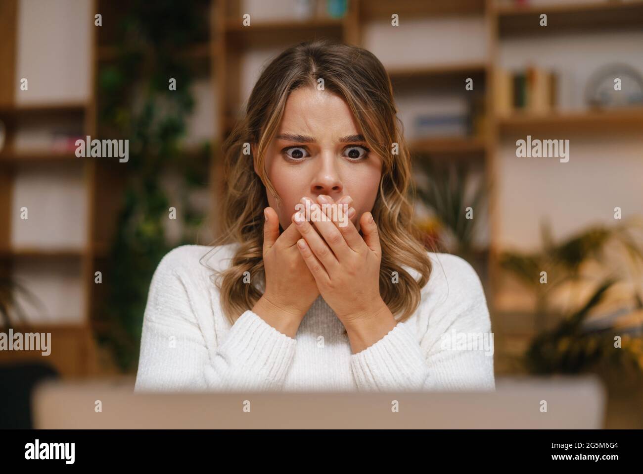 Frustrated confused young woman manager looking at laptop computer ...