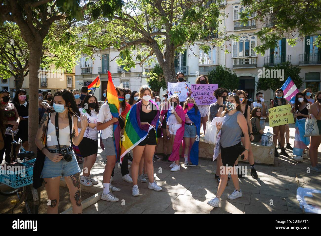 Protesters are seen holding placards and pride flags as they take part ...