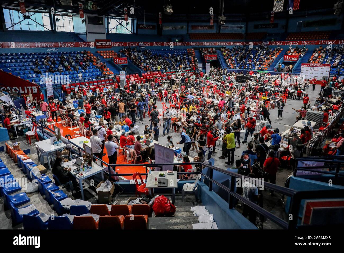 Health workers inoculate patients with the COVID-19 Pfizer-BioNTech ...