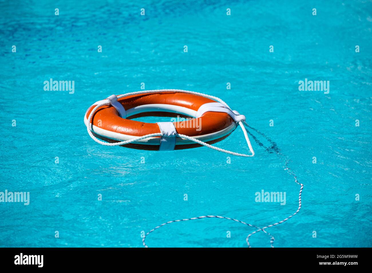 Lifebuoy pool ring float on blue water Stock Photo - Alamy