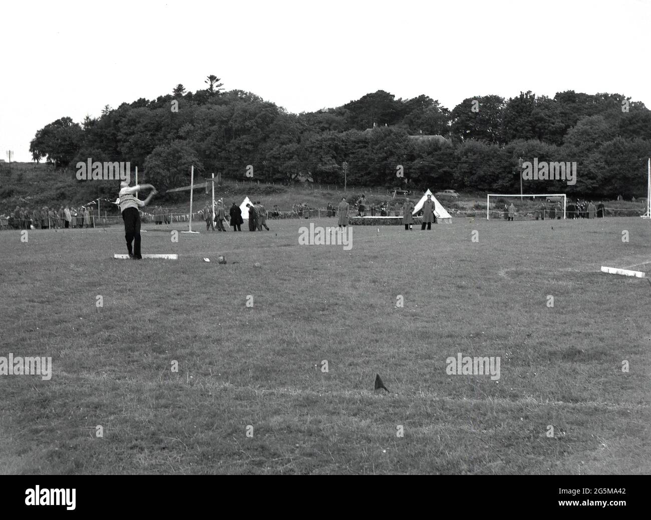 1956, historical, scottish highland games, contestant doing the hammer ...