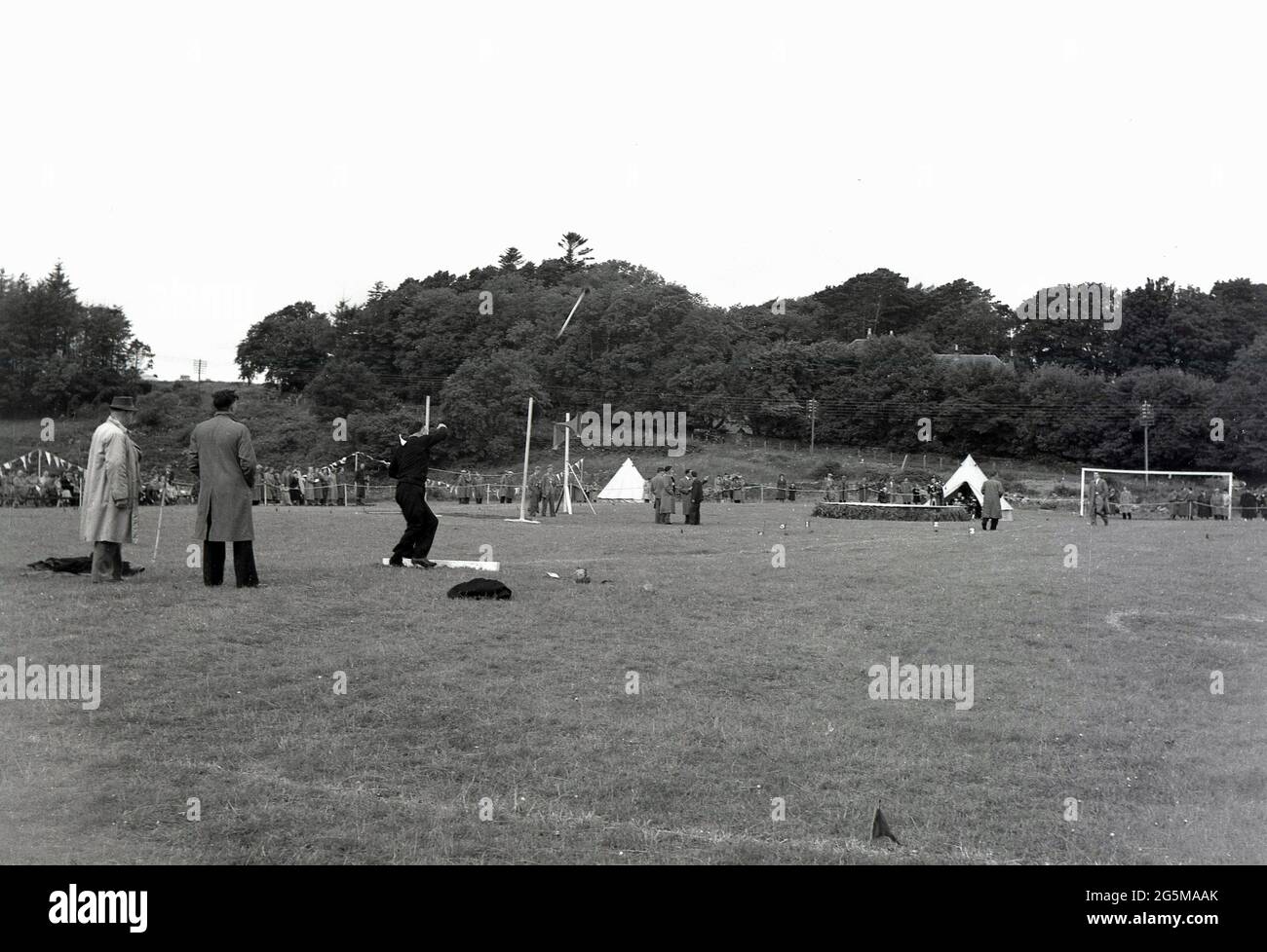 1956, historical, scottish highland games, man throwing the hammer ...