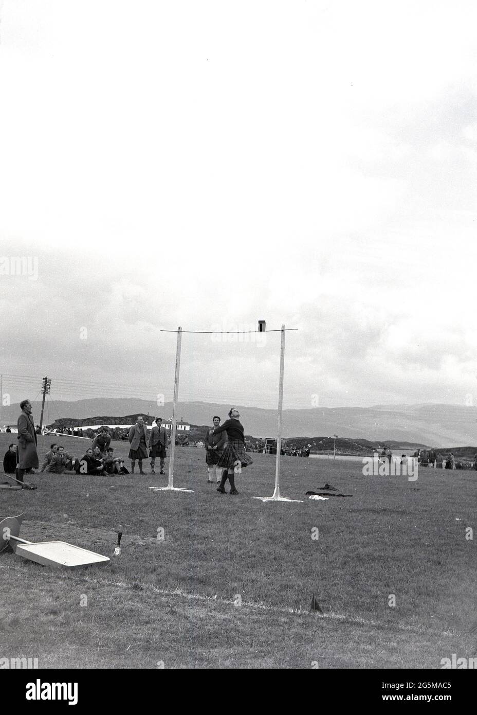 1956, historical, scottish highland games, weight throw, a male ...