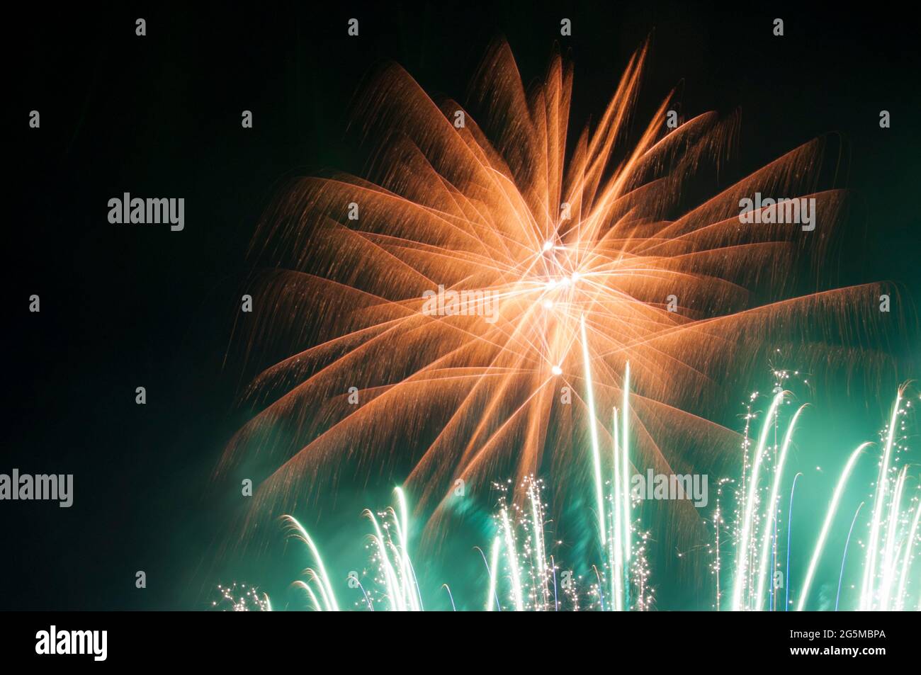 Firework exploding. Aqua and gold Stock Photo - Alamy