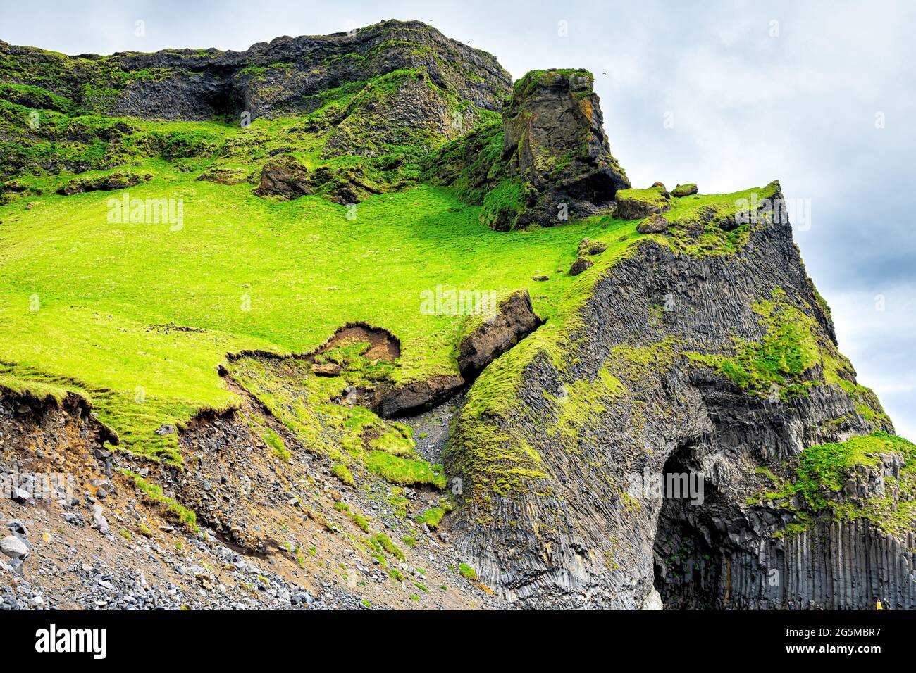 Icelandic green meadow field grass hill mountain rocky cliff landscape ...