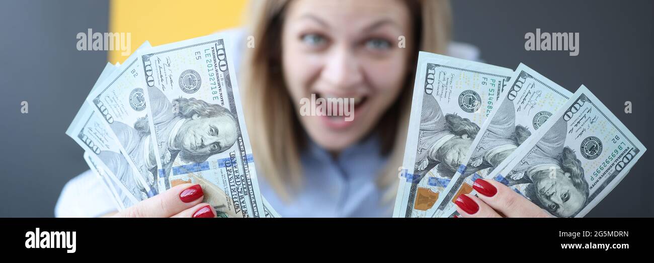 Happy woman screaming and holding lot of money in her hands clos Stock ...