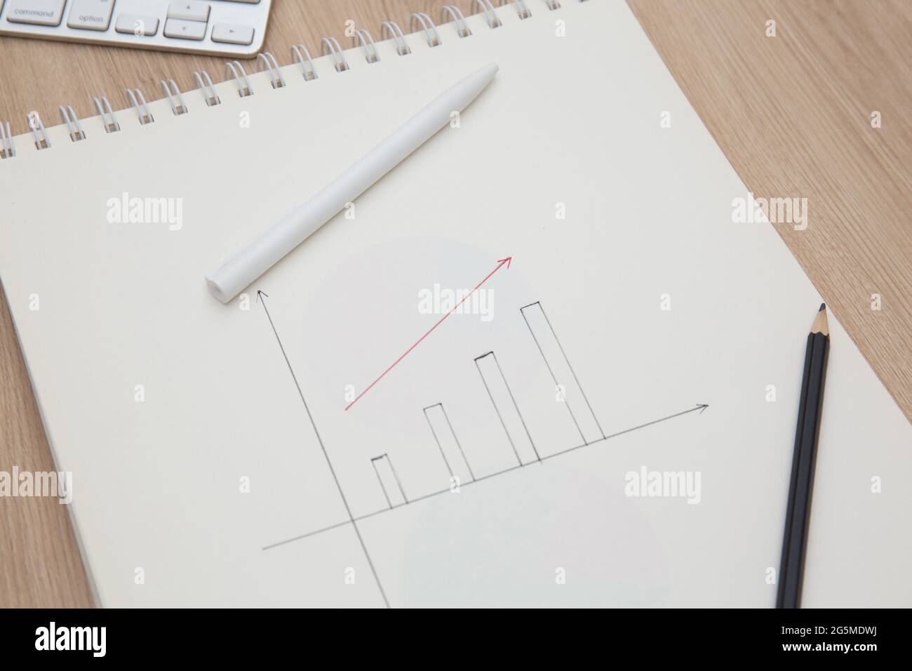 Shot of a drawn graph on a notebook with pencils Stock Photo - Alamy