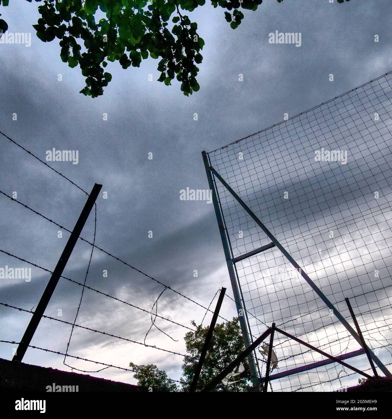 Fishnet and barbed wire fences, Conceptual photography, France Stock ...