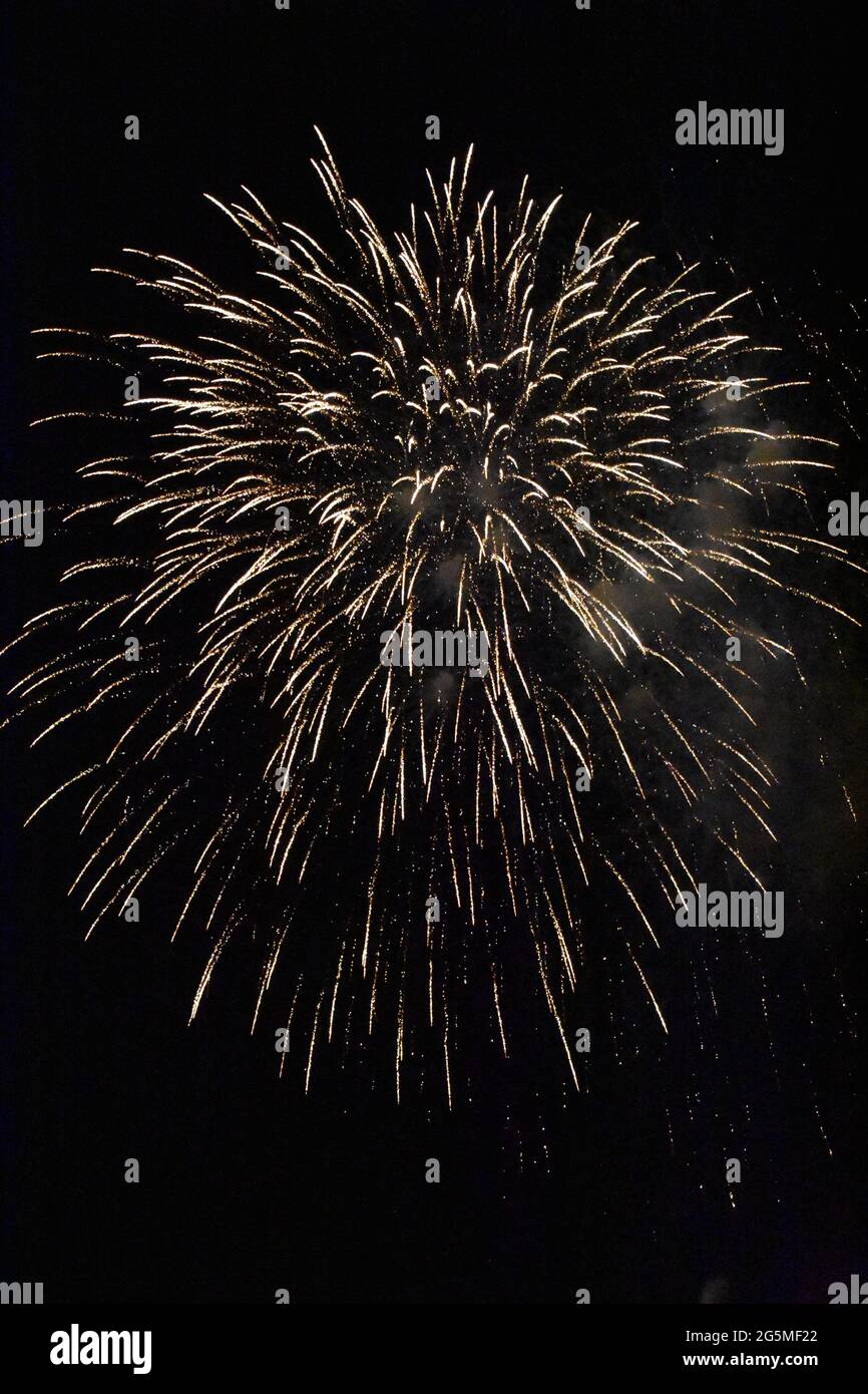 Gold fireworks exploding in the night sky Stock Photo - Alamy