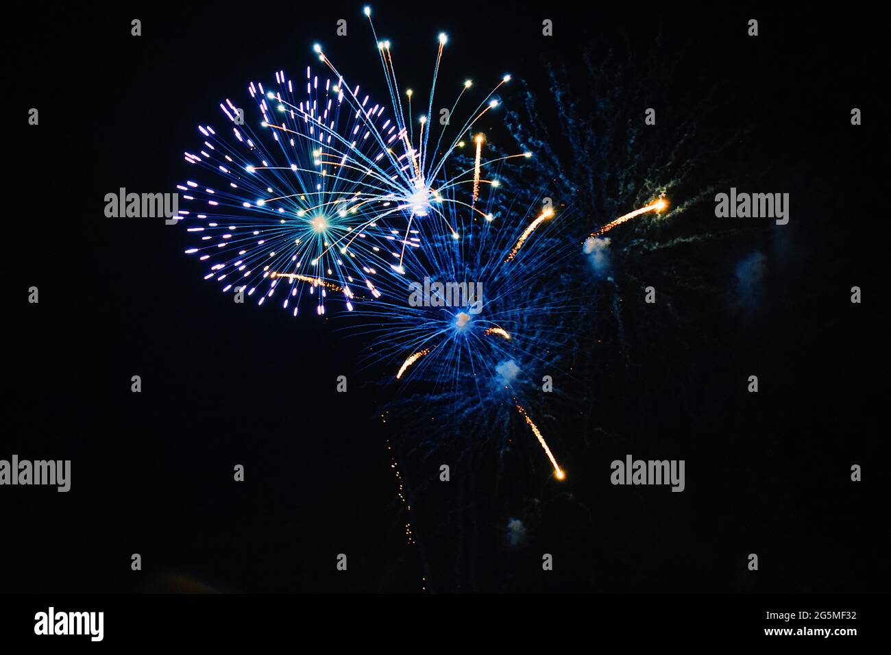 Blue fireworks exploding in the night sky Stock Photo - Alamy