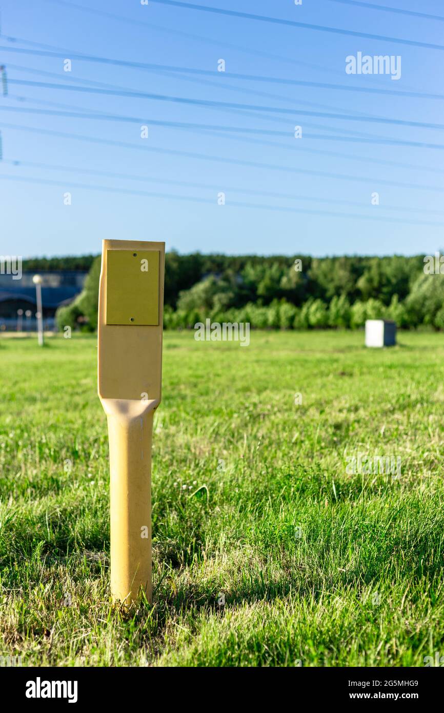 Yellow pillar with a sign - pointer. A warning Stock Photo - Alamy