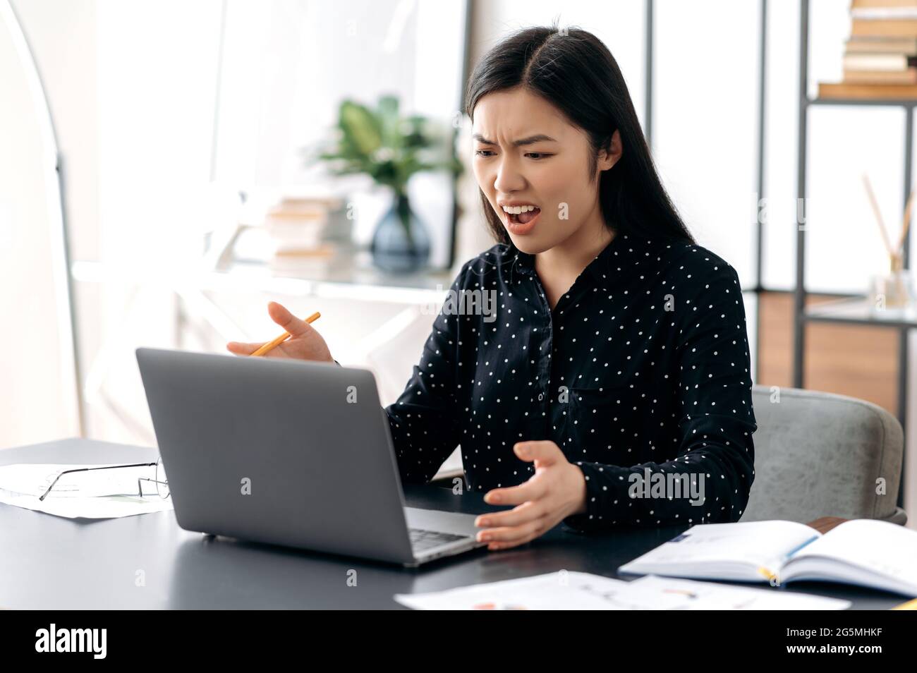 Unpleasant video conversation. Annoyed asian girl, ceo, office worker ...