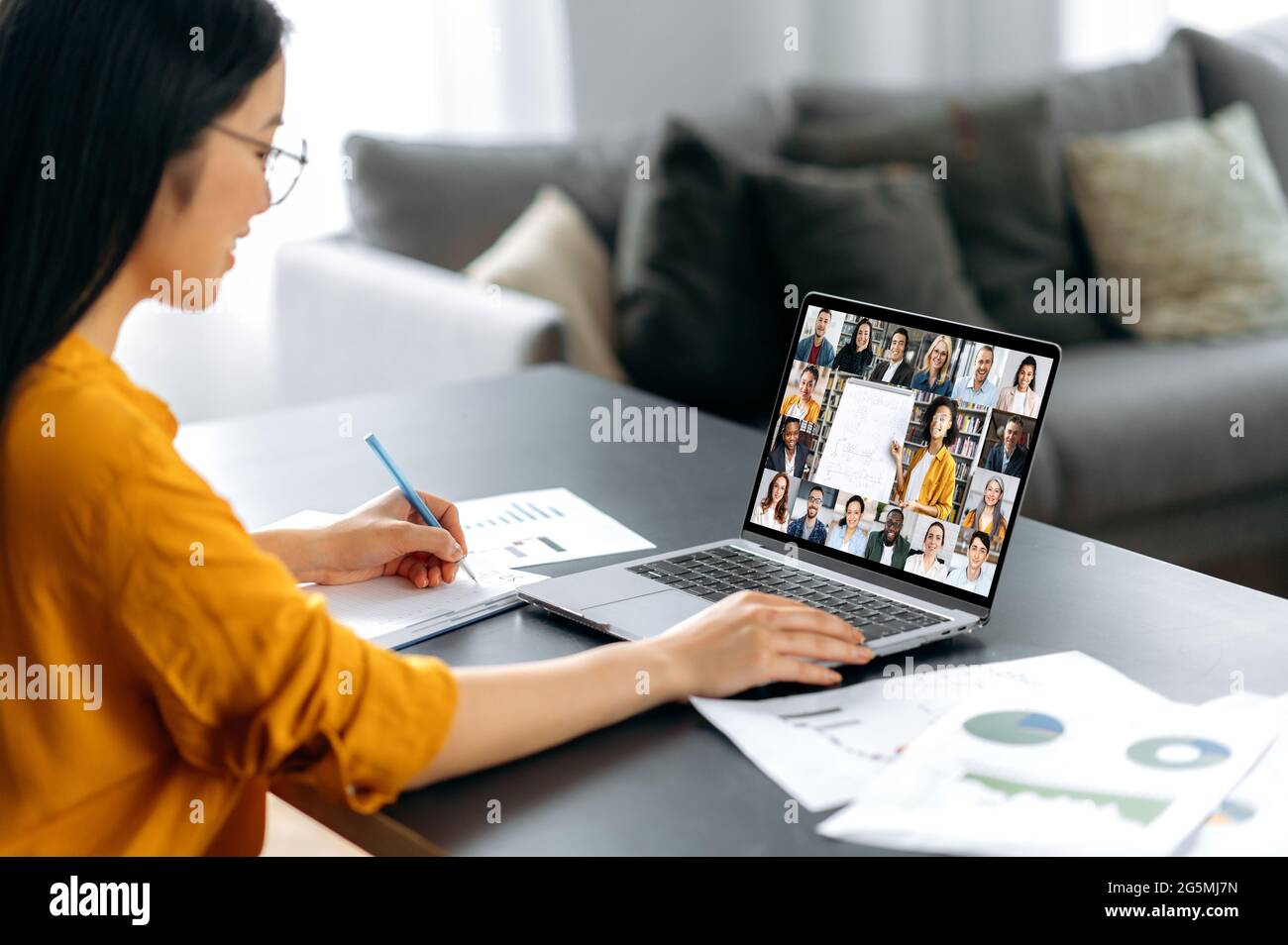 Video conference with teacher and students. Clever asian female student ...