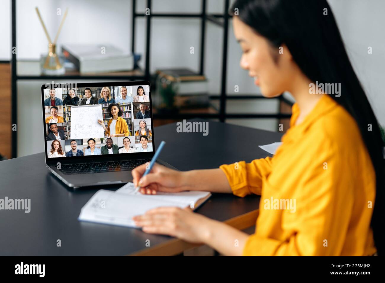 Online education. Smart japanese student girl gains knowledge watching ...