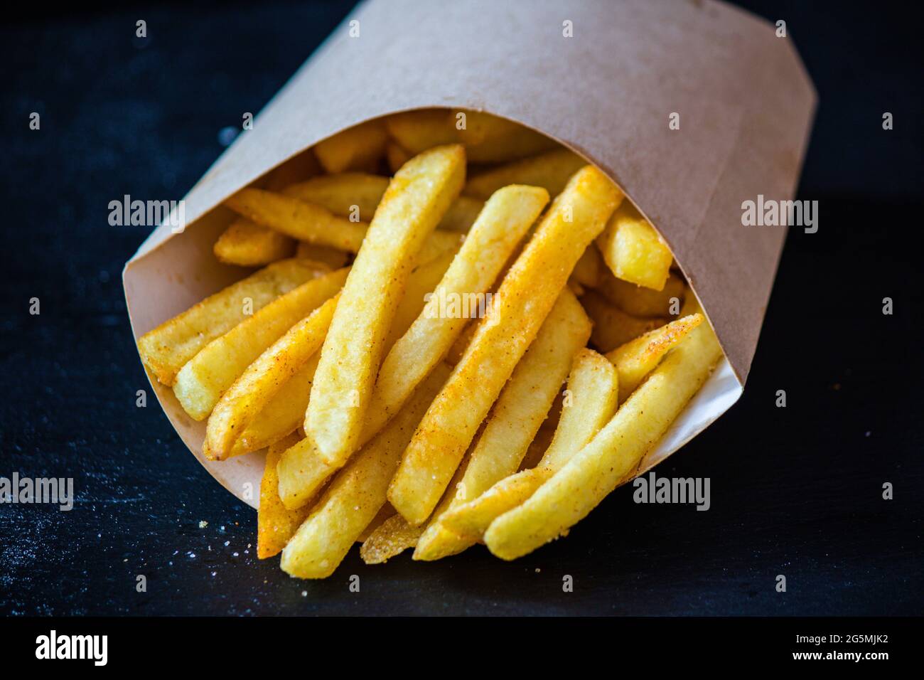 Closeup shot of salty french fries in a paper pack Stock Photo - Alamy