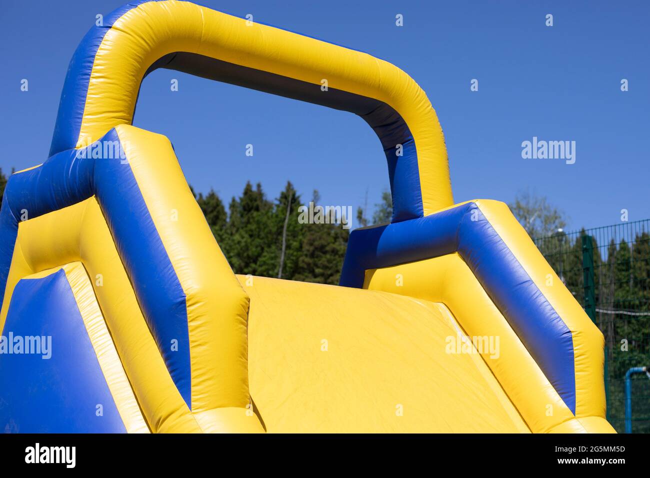 Children climb an inflatable slide. Inflatable obstacle course for fun ...