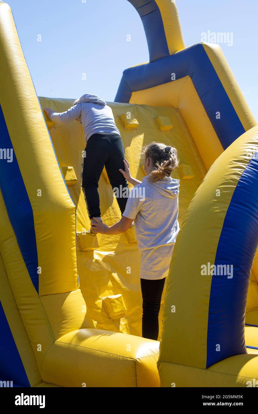 A child climbs an inflatable slide. Obstacle course for children ...